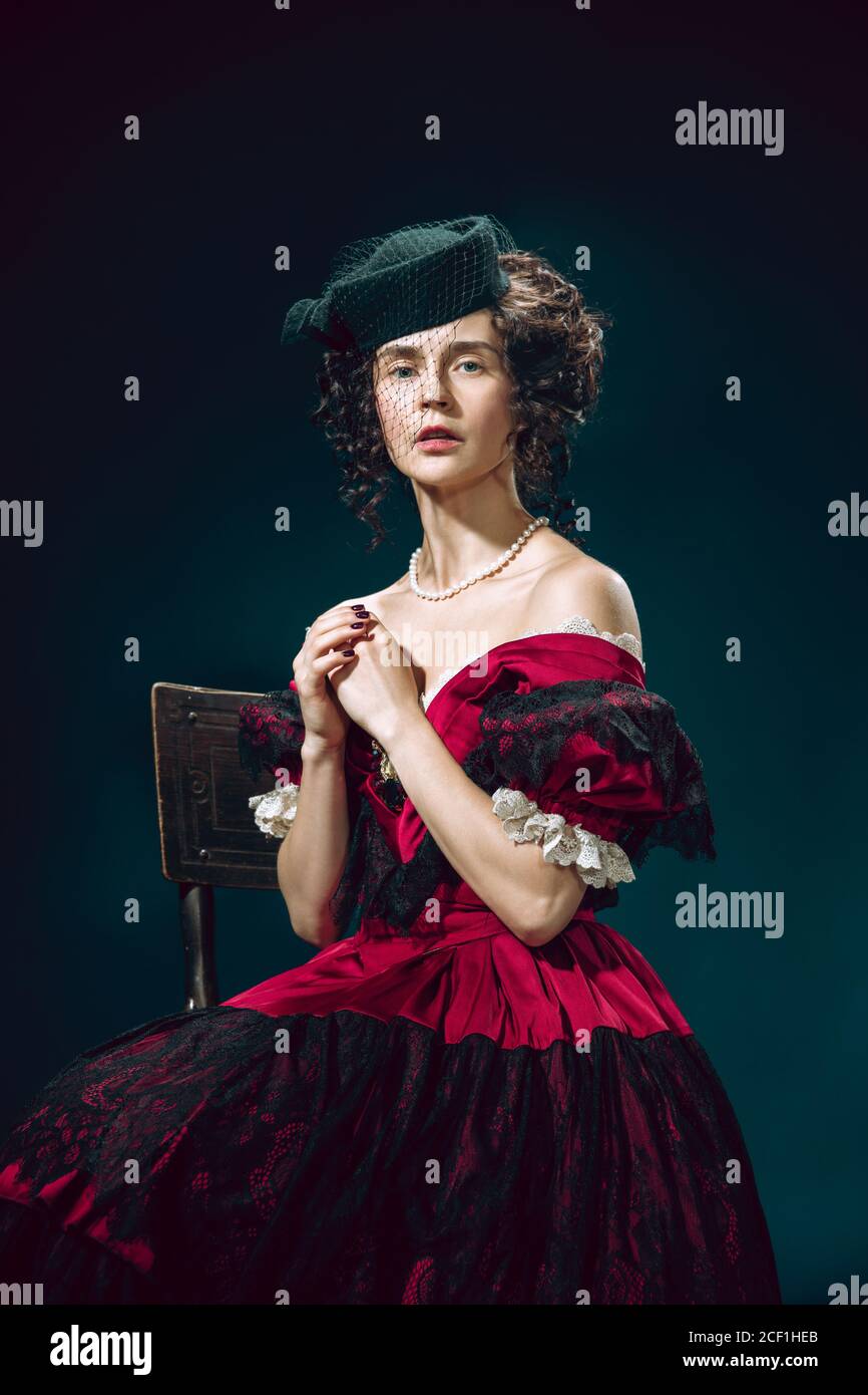Tender. Young woman as Anna Karenina isolated on dark blue background ...