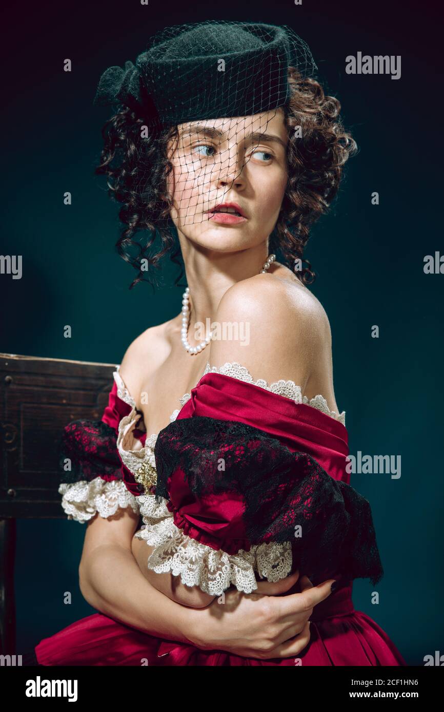 Tensioned. Young woman as Anna Karenina isolated on dark blue ...