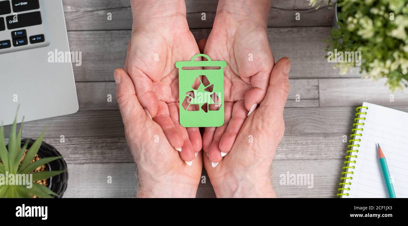 Hands holding a recycling bin; Concept of recycling Stock Photo - Alamy