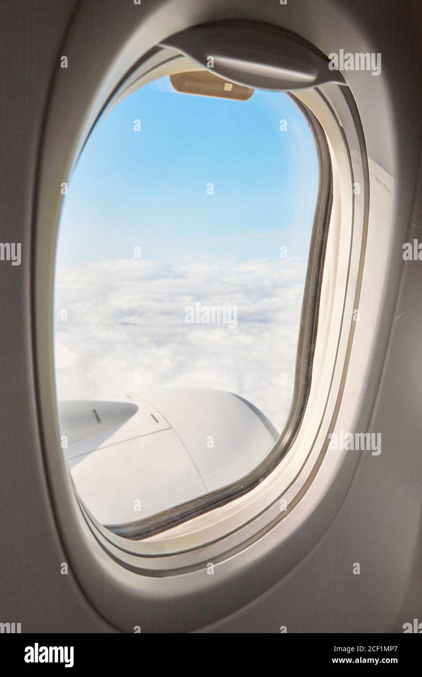Open window with sky on a comercial aeroplane. Cabin interior. Vertical ...