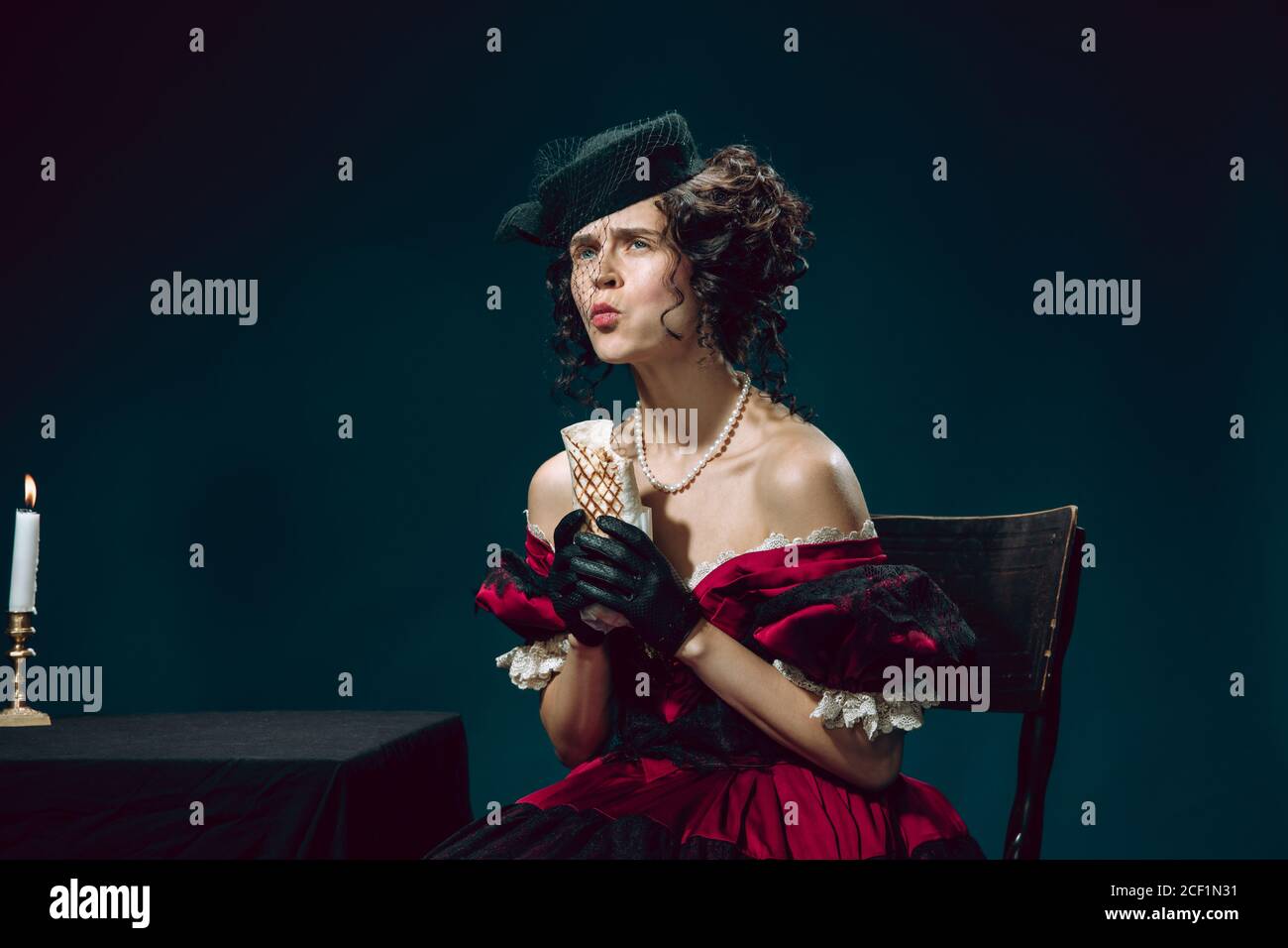 Needed taste. Young woman as Anna Karenina isolated on dark blue ...