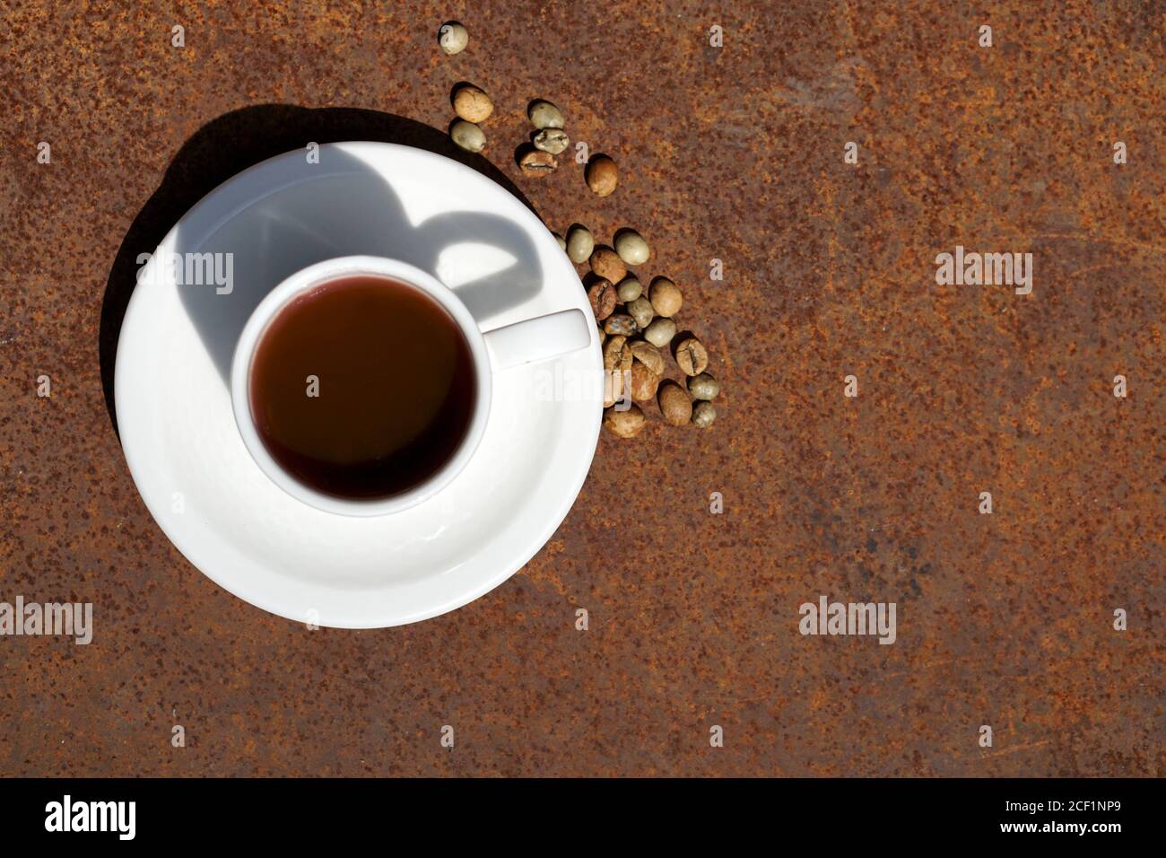 Flat lay Coffee composition with white cup and beans of coffe on iron ...