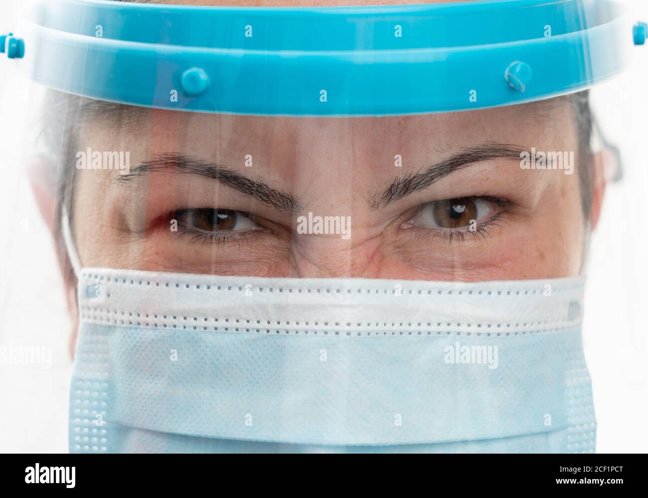 Close-up of angry adult woman eyes expression wearing medical or ...