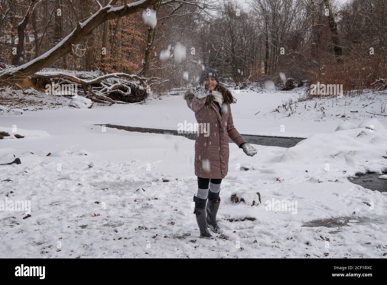 Young woman throwing a snowball Stock Photo - Alamy
