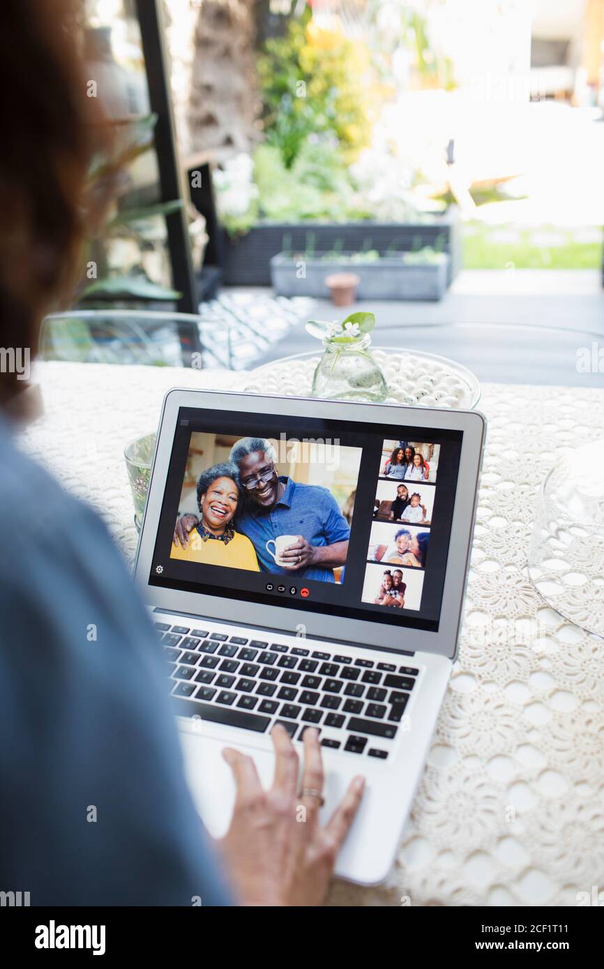 Woman video chatting with family and friends on laptop screen Stock ...