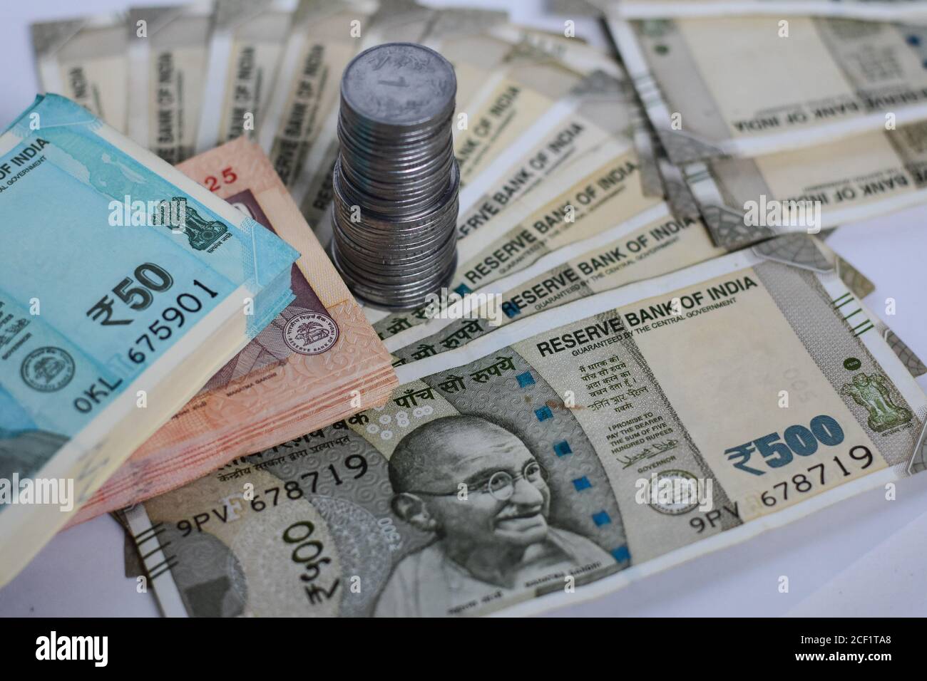 In this photo illustration five hundred rupee notes are seen with coins ...
