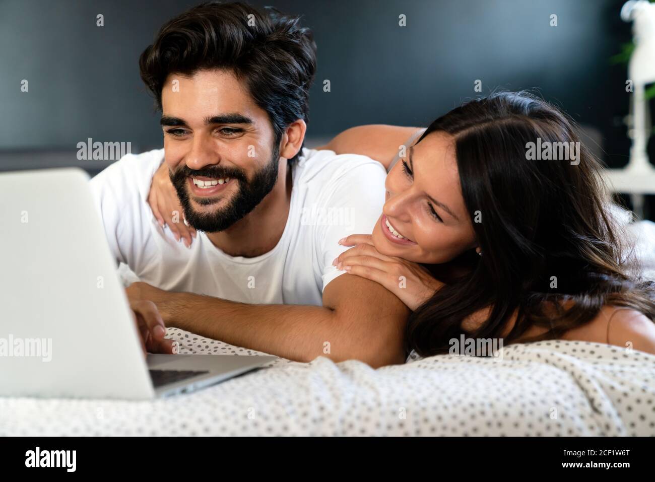Romantic happy couple in love relaxing at home having fun. People ...