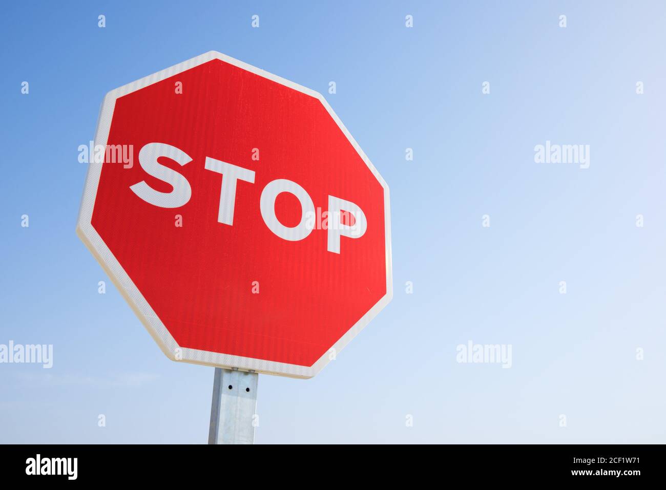 Stop traffic sign with clear blue sky Stock Photo - Alamy