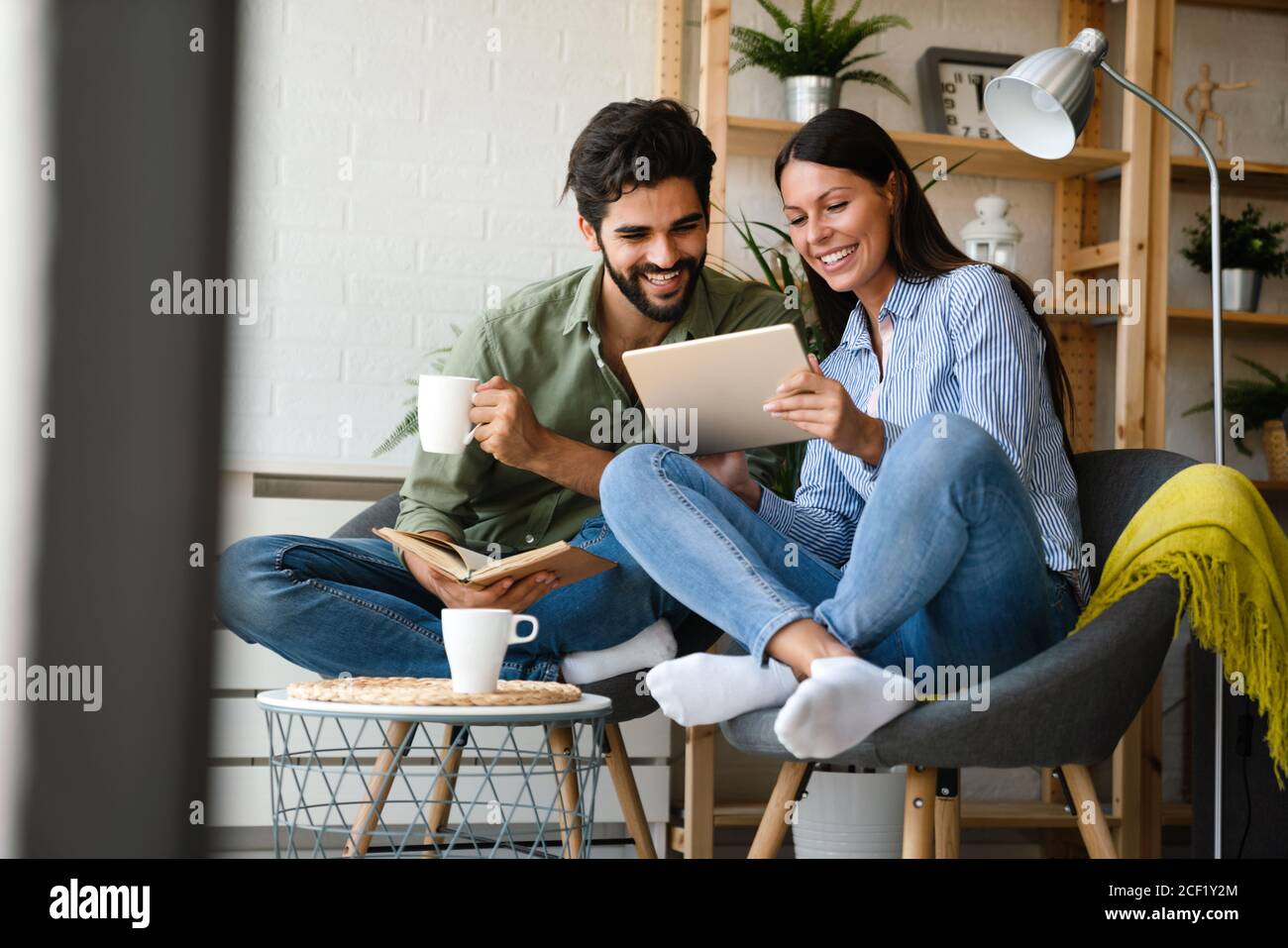 Spending nice time at home. Couple bonding to each other and smiling ...