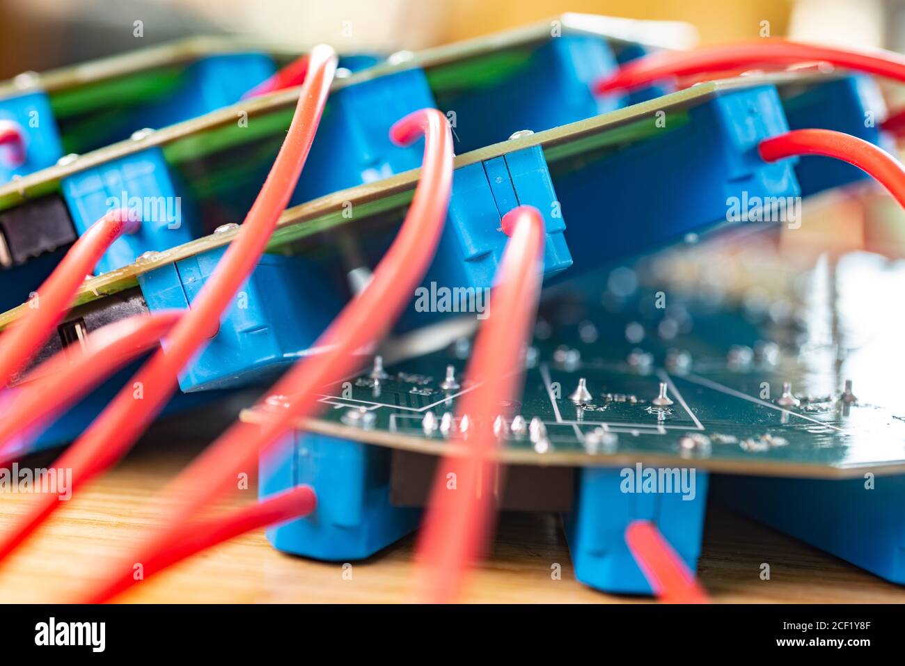 Close-up of a large green microcircuit with red HI-voltage wires and ...