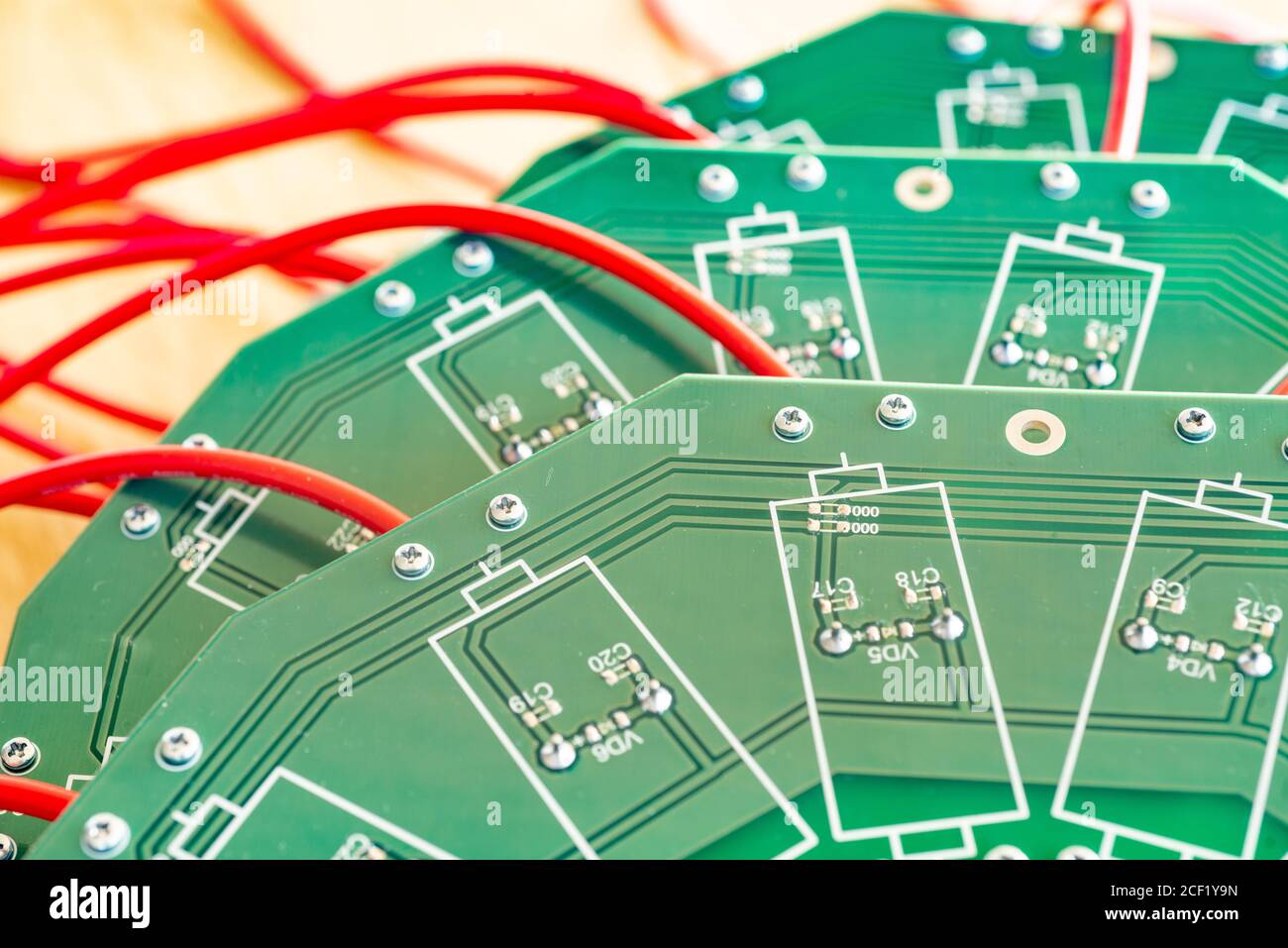 Close-up of a large green microcircuit with red HI-voltage wires and ...