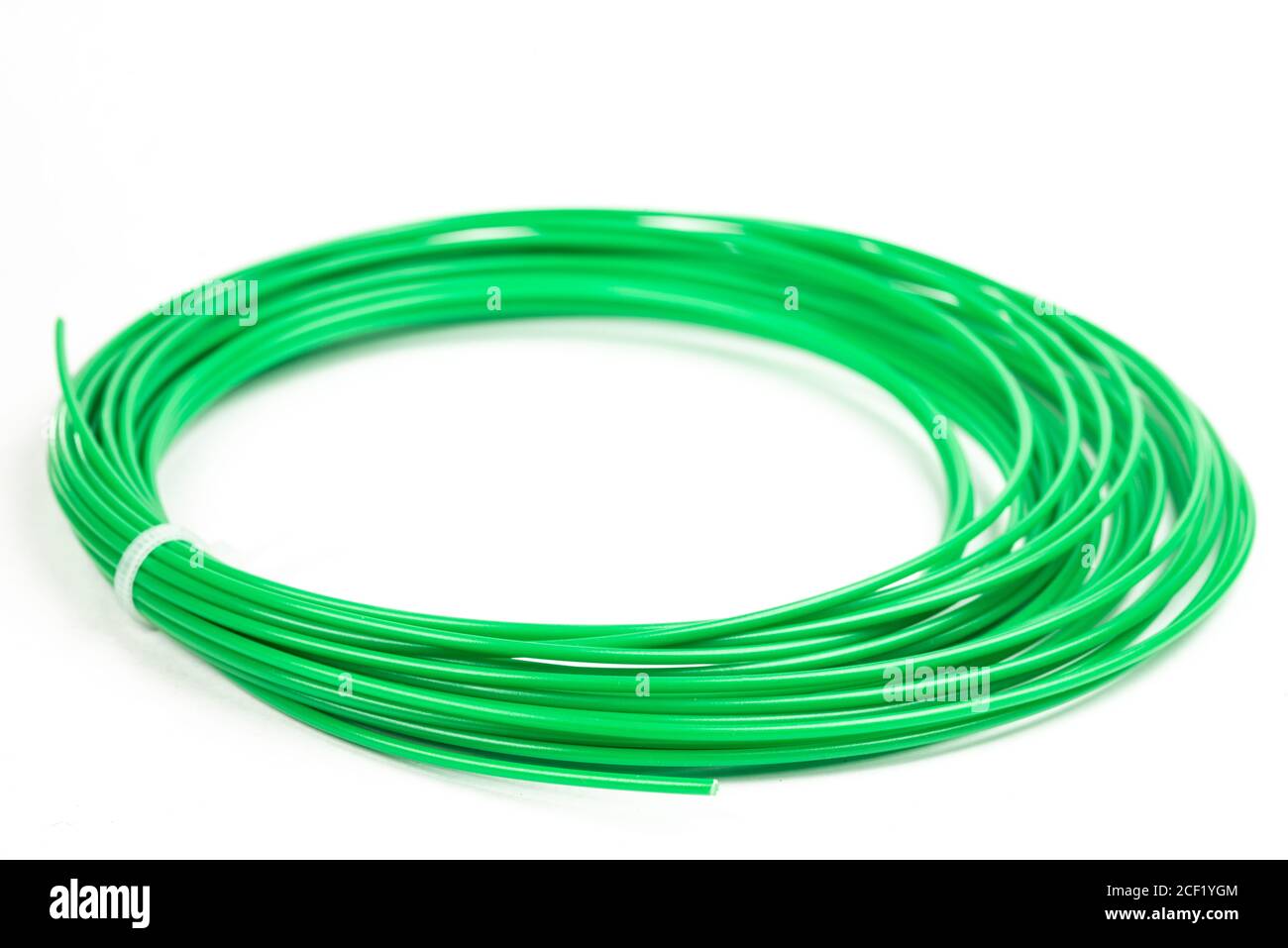 Top view of green rolled filament 3D pen PLA isolated on white. Closeup ...