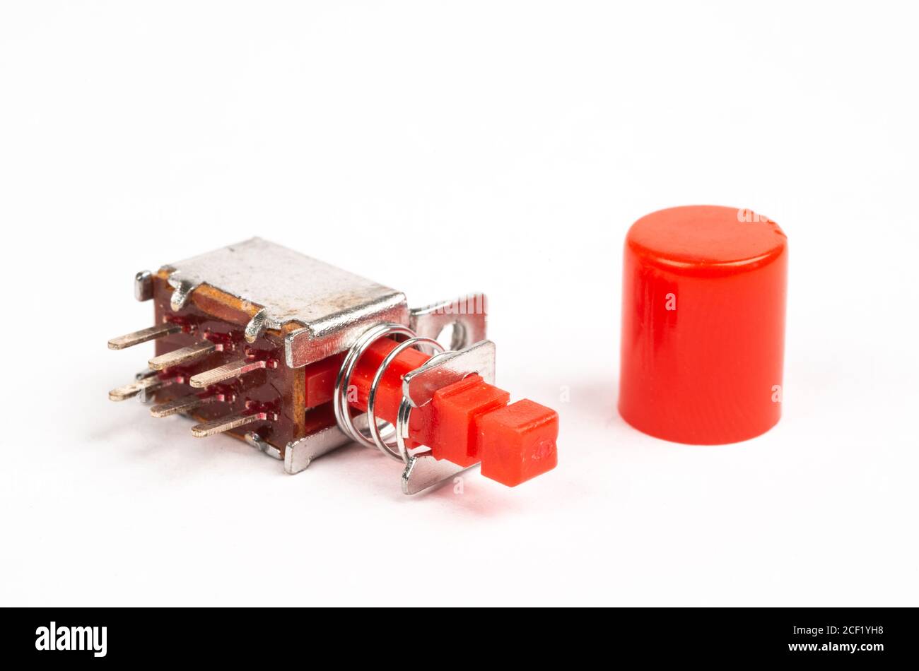 Miniature electric switches with red caps on isolated white background ...