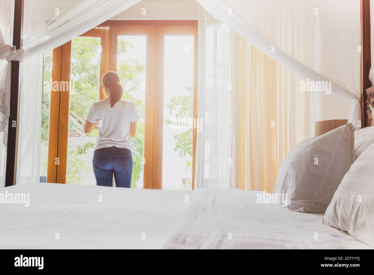 Asian women in hotel room open the window on summer vacation Stock ...