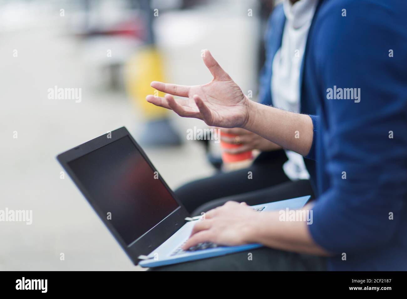 Business people with laptop talking outdoors Stock Photo - Alamy