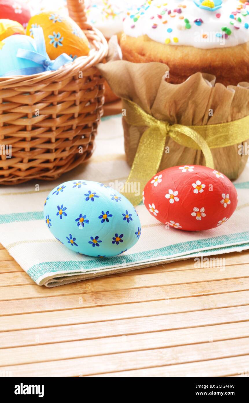 Easter eggs, cake and basket on the tabletop Stock Photo - Alamy