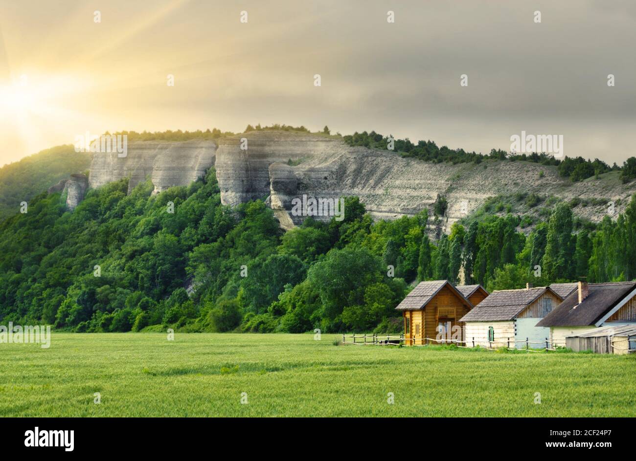 Farm house under mountain Stock Photo - Alamy