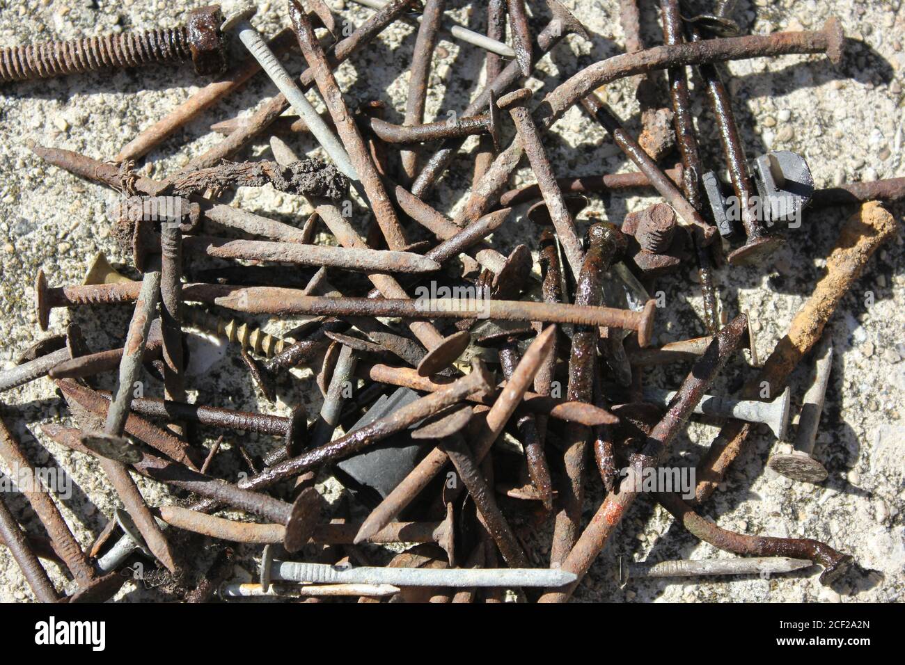 A pile of rusted nails laying on the ground Stock Photo - Alamy
