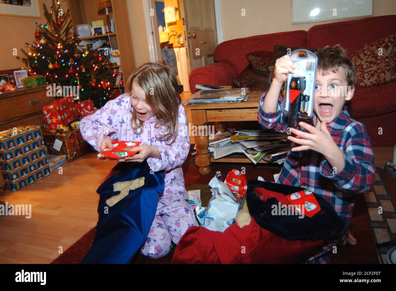 Children opening Christmas presents on Christmas Day morning; UK Stock ...
