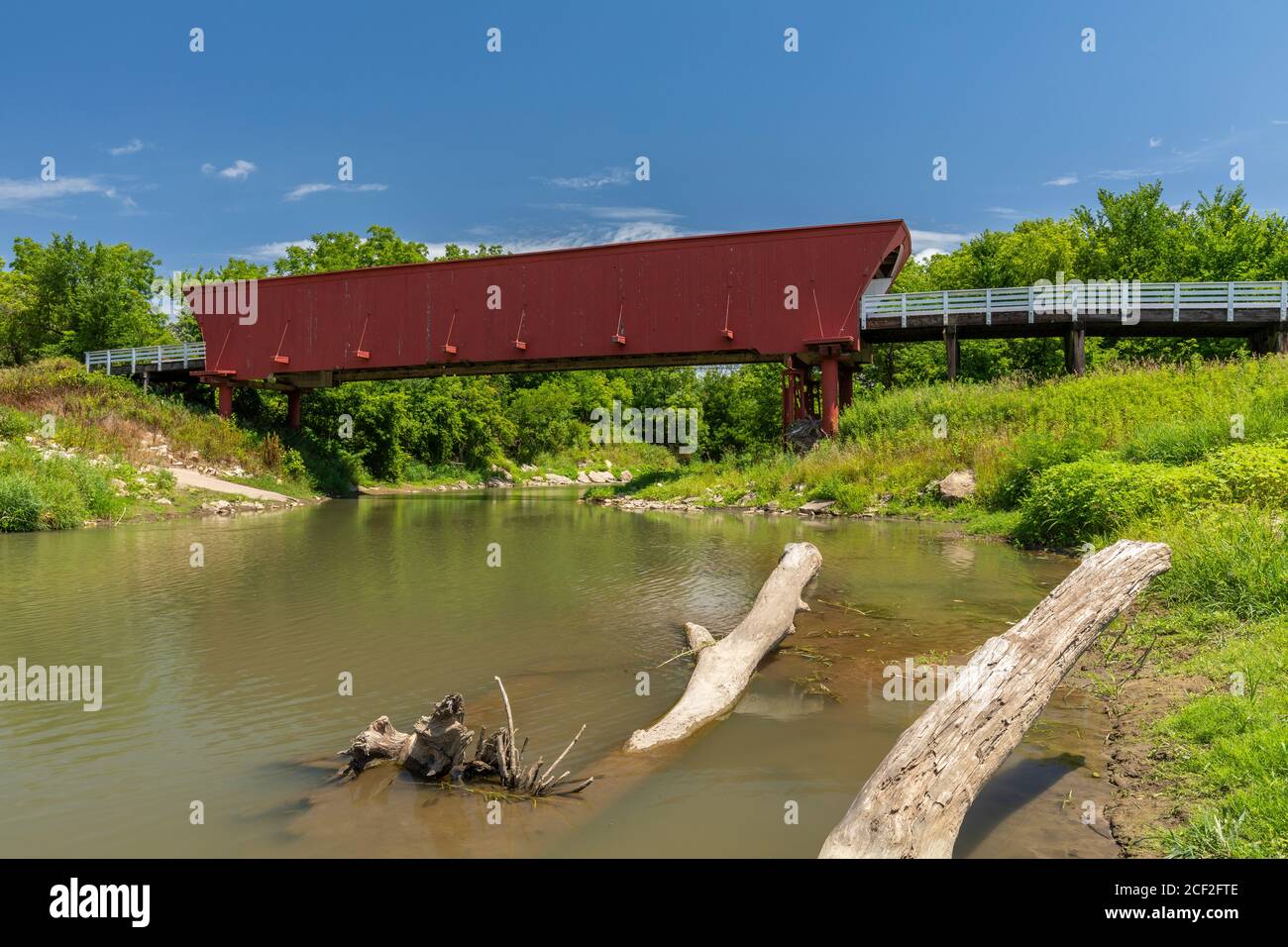 An old red covered bridge over a river Stock Photo - Alamy