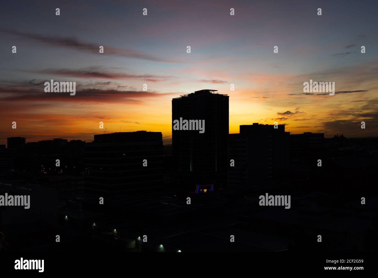 Sunset behind city buildings Stock Photo - Alamy