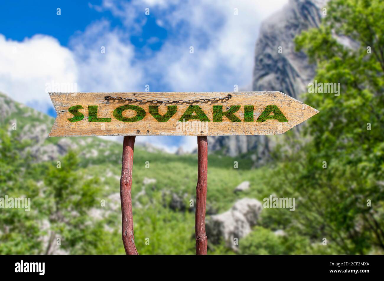 Slovakia wooden arrow road sign against mountains background. Travel to ...