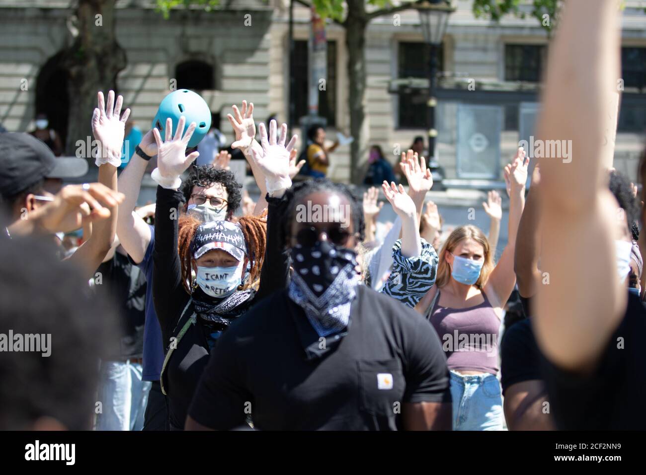 Black Lives matter protestors hold up their hands at a protest in ...