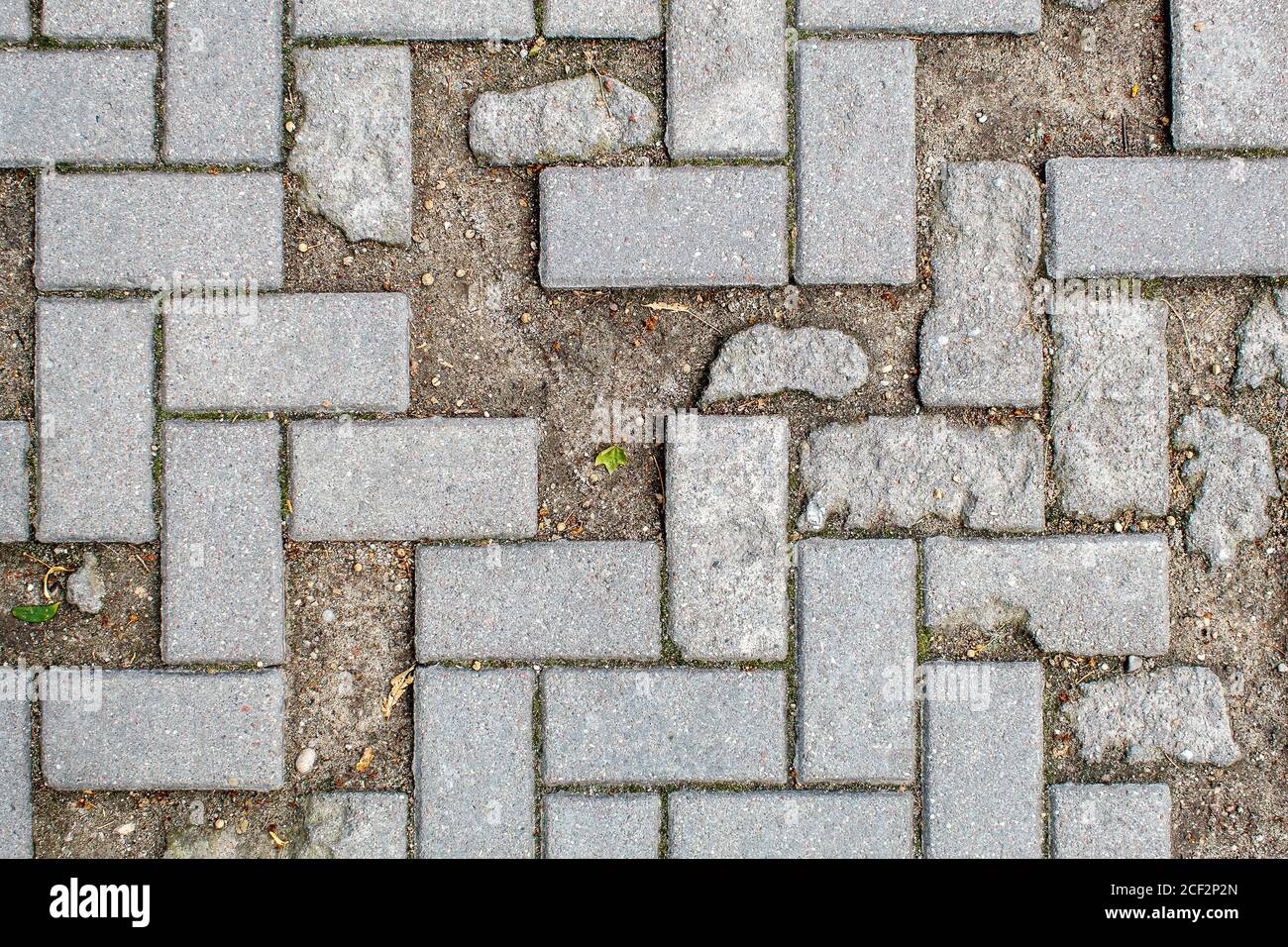 pavement with broken broken tiles. beautiful brick background with ...