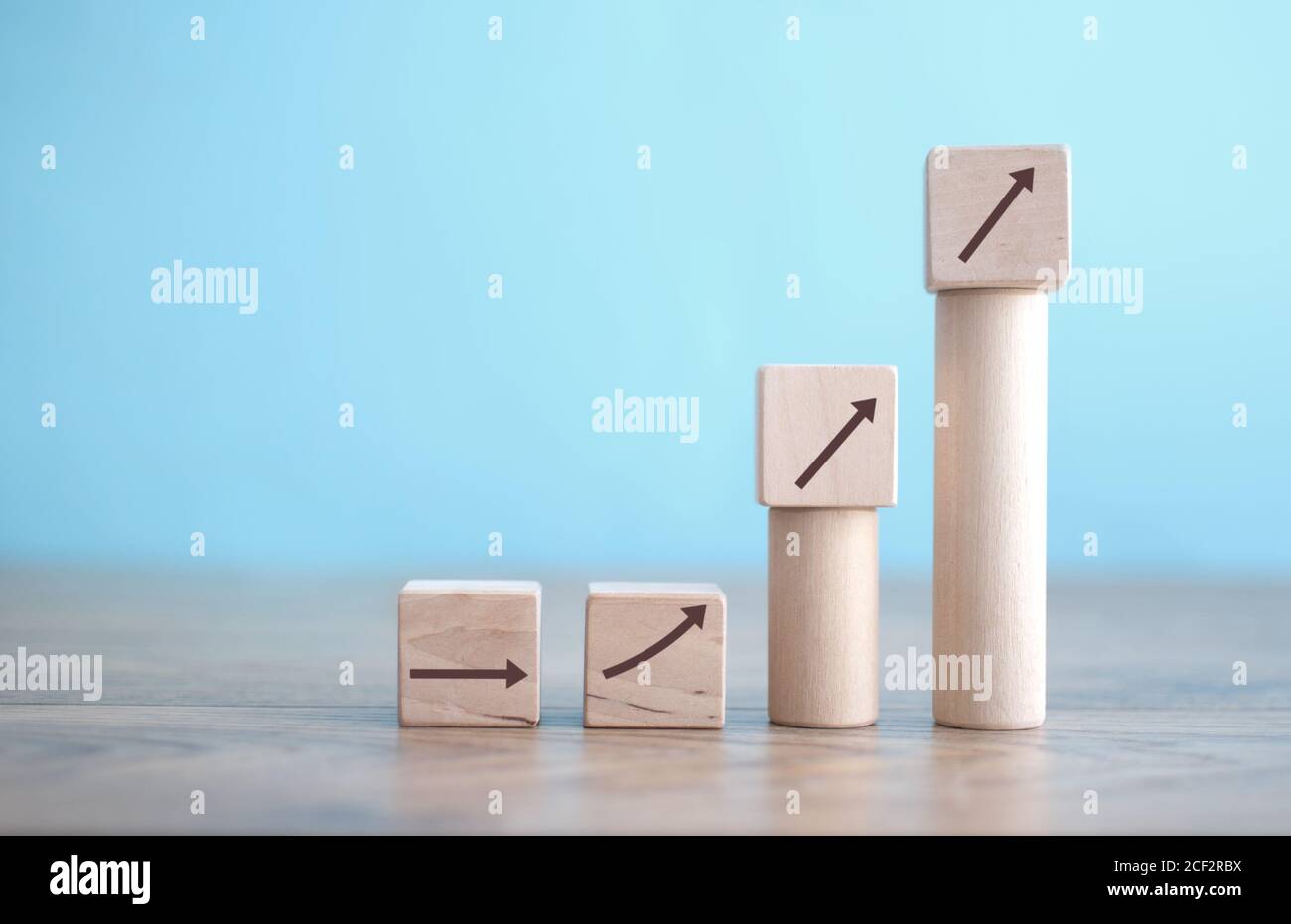 Business growth building blocks on podiums with arrows heading upwards ...