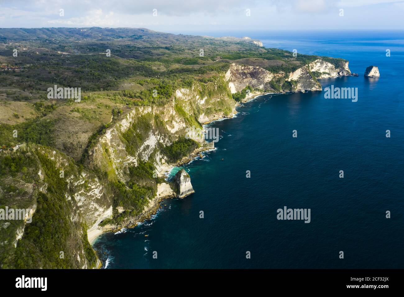View from above, stunning aerial view of a green limestone cliff bathed ...