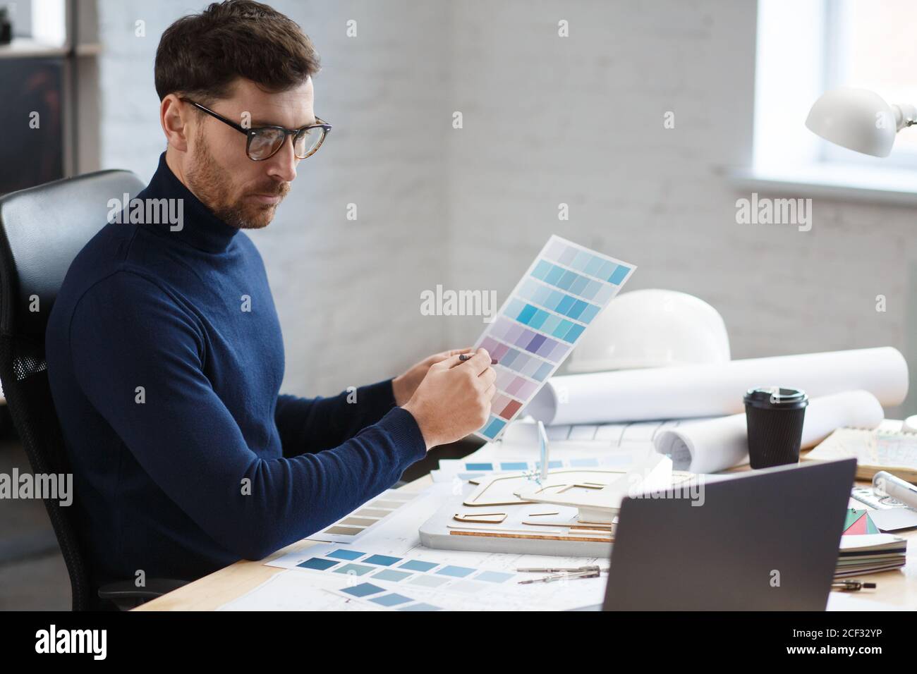 Architect working in office with color palette. Engineer select colors ...