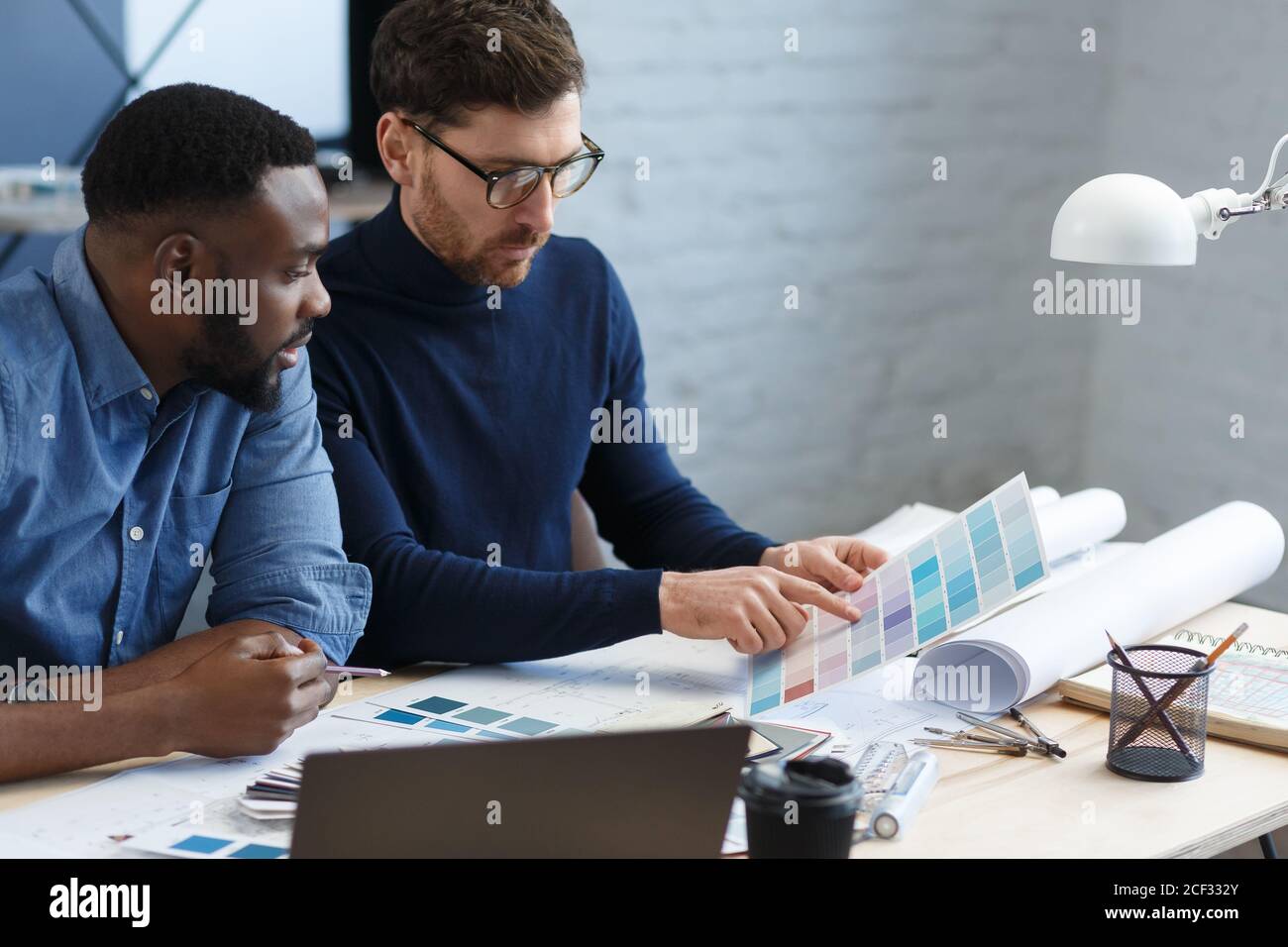 Multiracial engineer team working in office with color palette ...