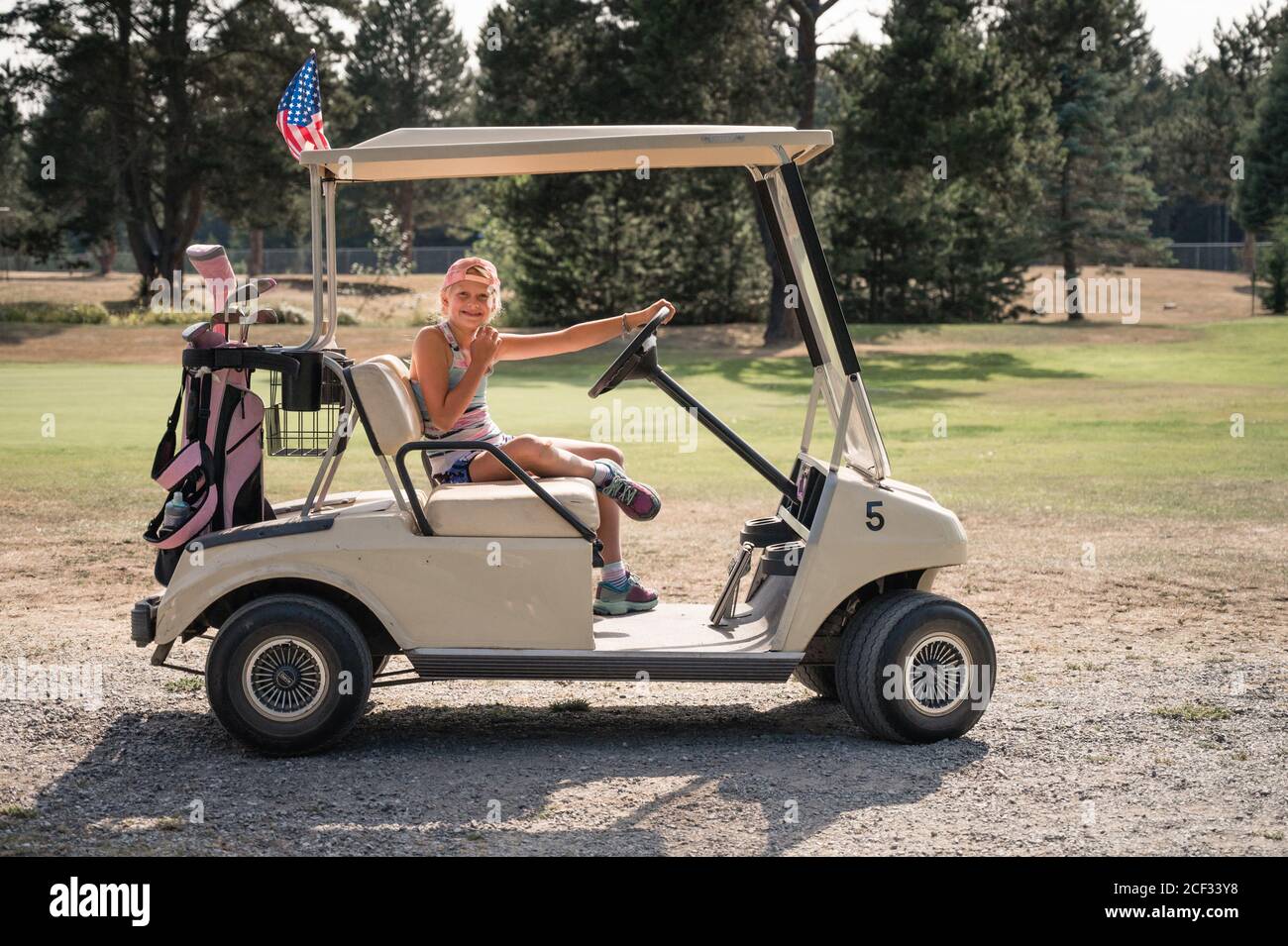 Young Girl Sitting in Golf Cart With Pink Golf Bag on Sunny Day Stock ...