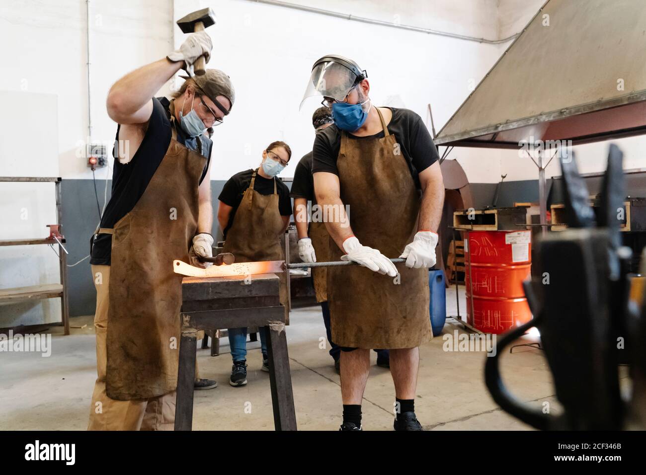 Men forging iron hi-res stock photography and images - Alamy
