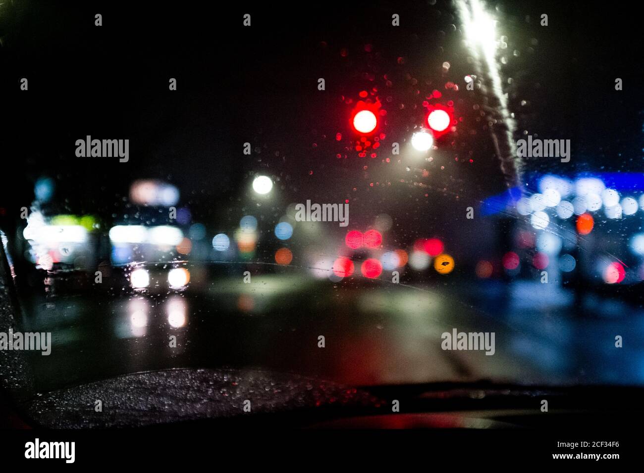 Rainy Windshield with Traffic and City Lights in Background at Night ...