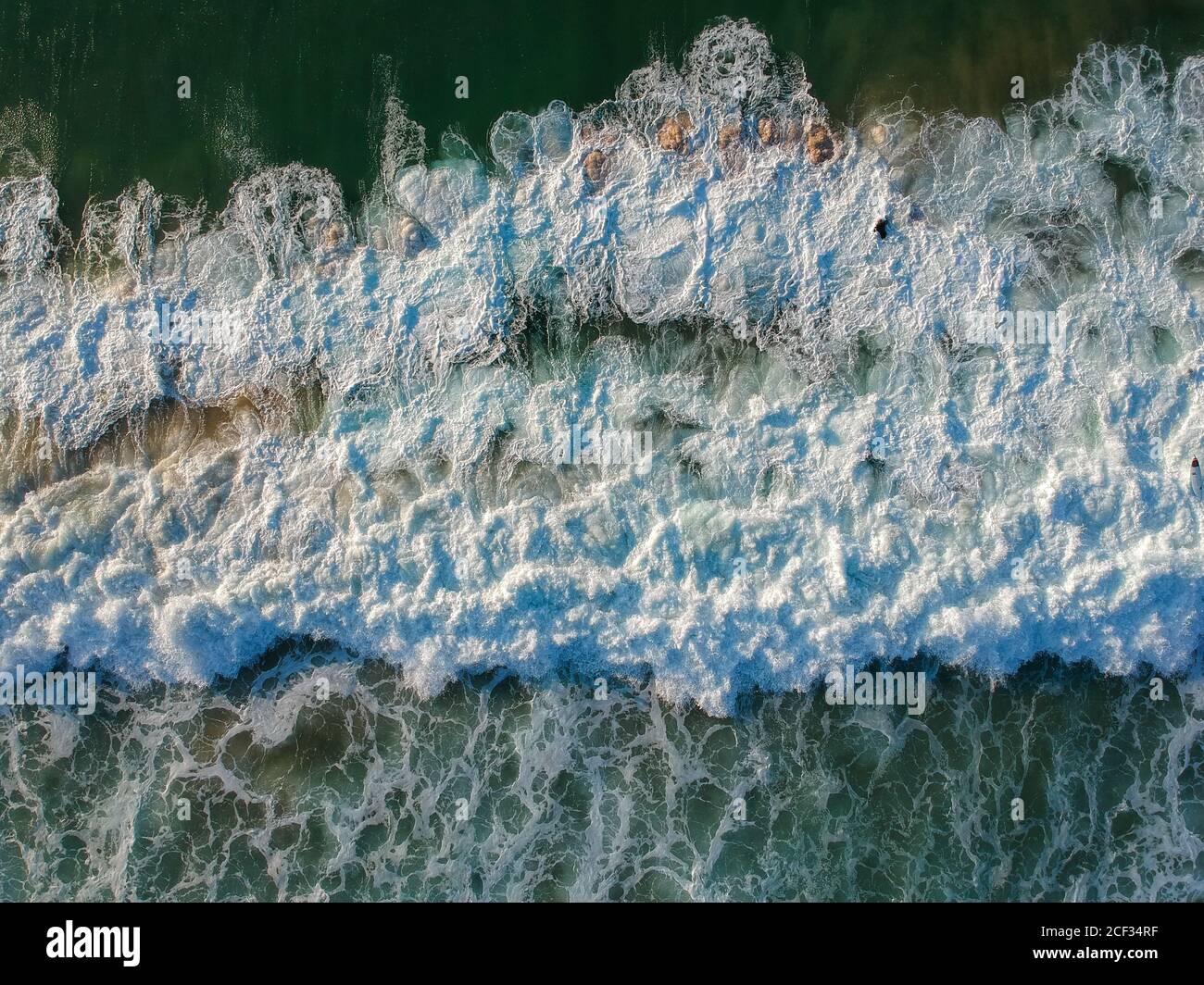 Aerial view of surfers and big wave in the ocean. Top view Stock Photo ...