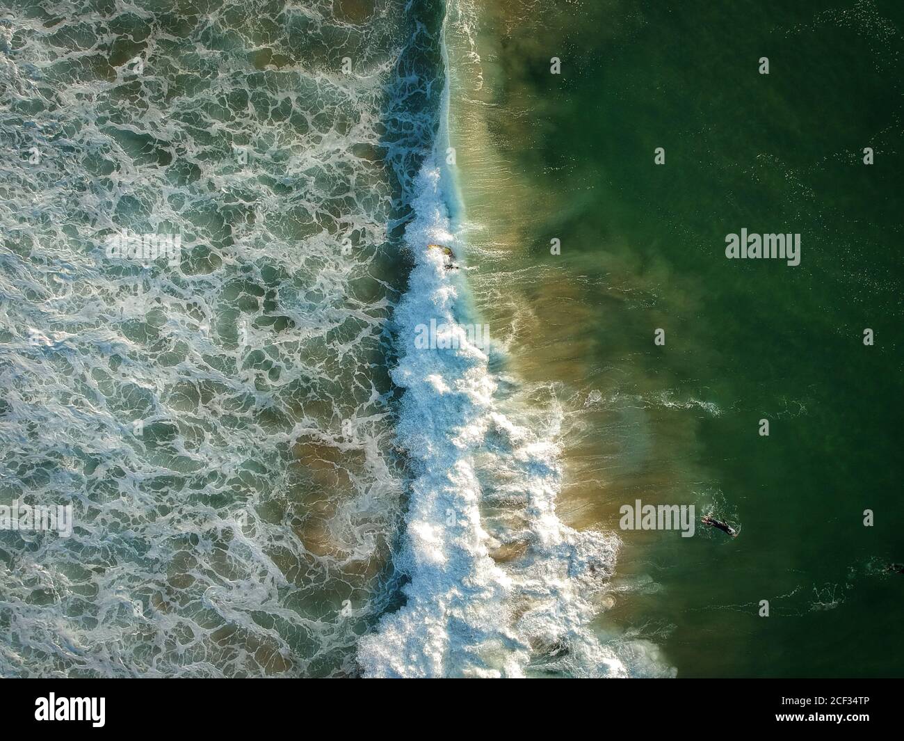 Aerial view of surfers and big wave in the ocean. Top view Stock Photo ...