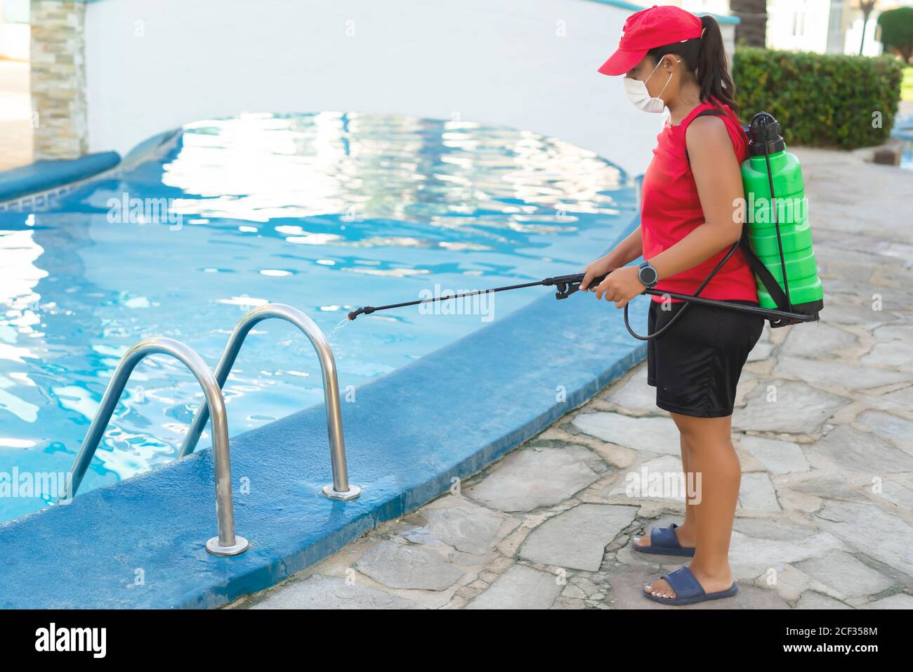 cleaning staff disinfecting the pool Stock Photo - Alamy