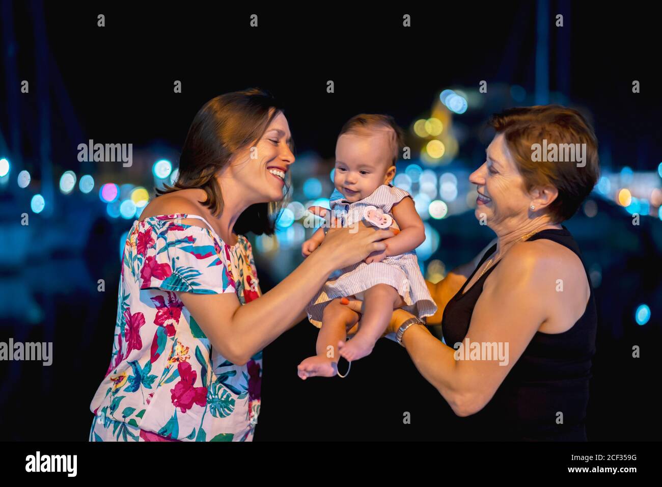 family enjoying baby girl Stock Photo - Alamy