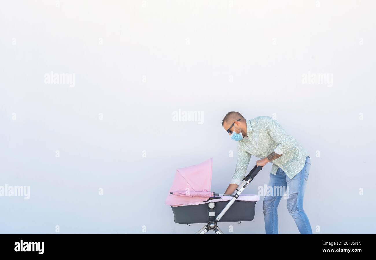 father tucking his baby in his stroller Stock Photo - Alamy