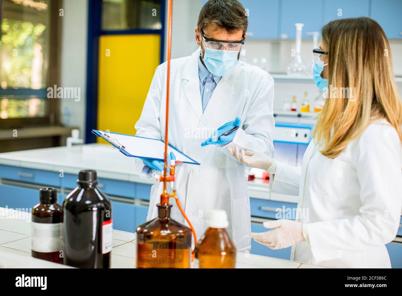 Young researchers analyzing chemical data in the laboratory Stock Photo ...