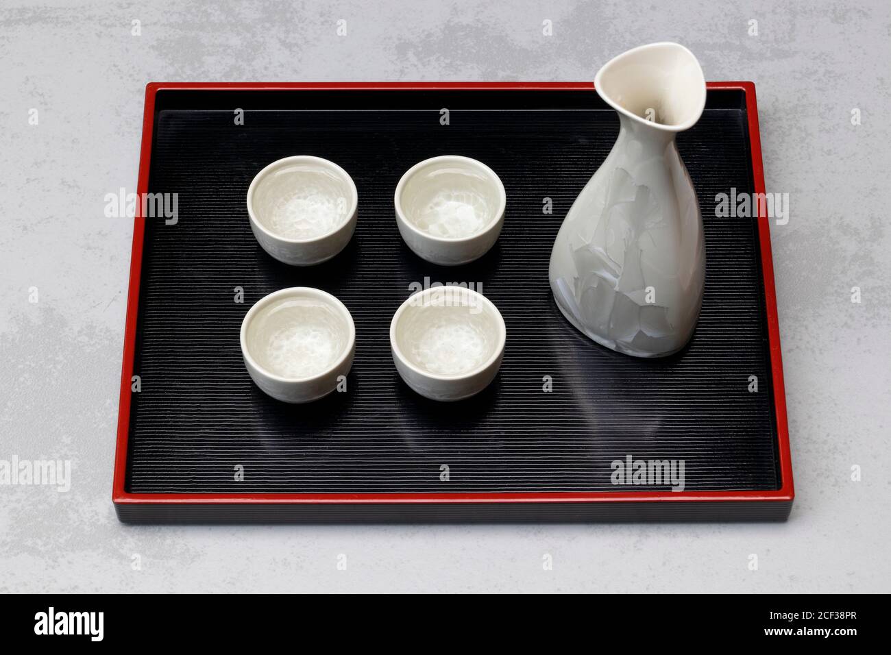 Traditional Japanese sake set with sake on a black tray Stock Photo - Alamy
