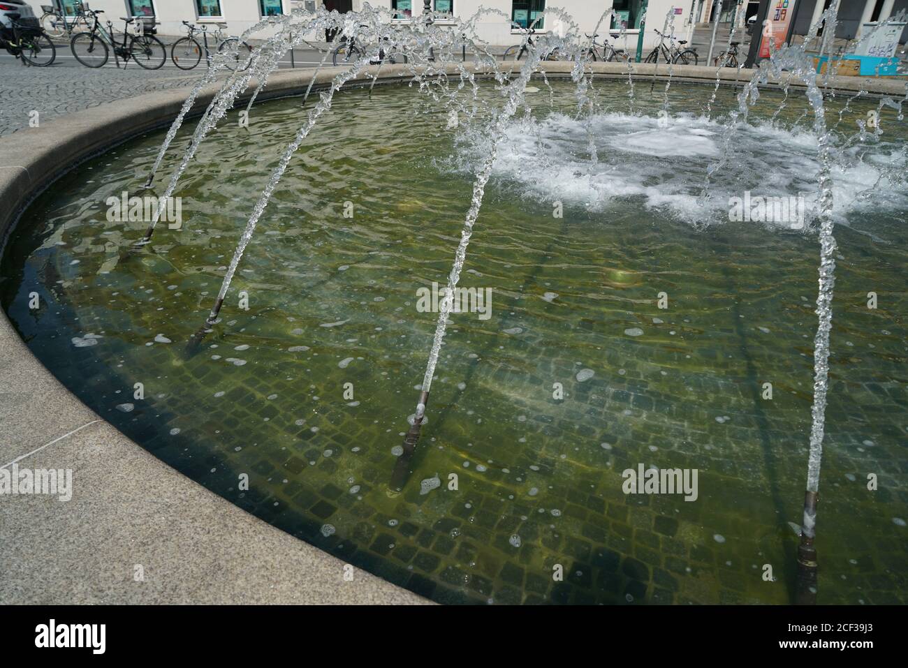Round fountain in the center of a city Stock Photo - Alamy