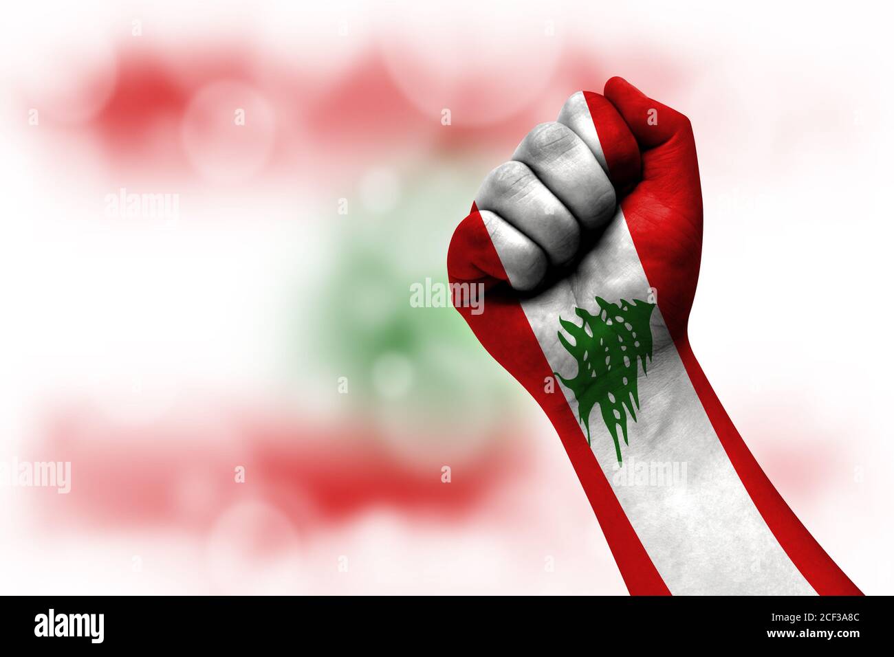 Flag of Lebanon painted on male fist, strength,power,concept of ...