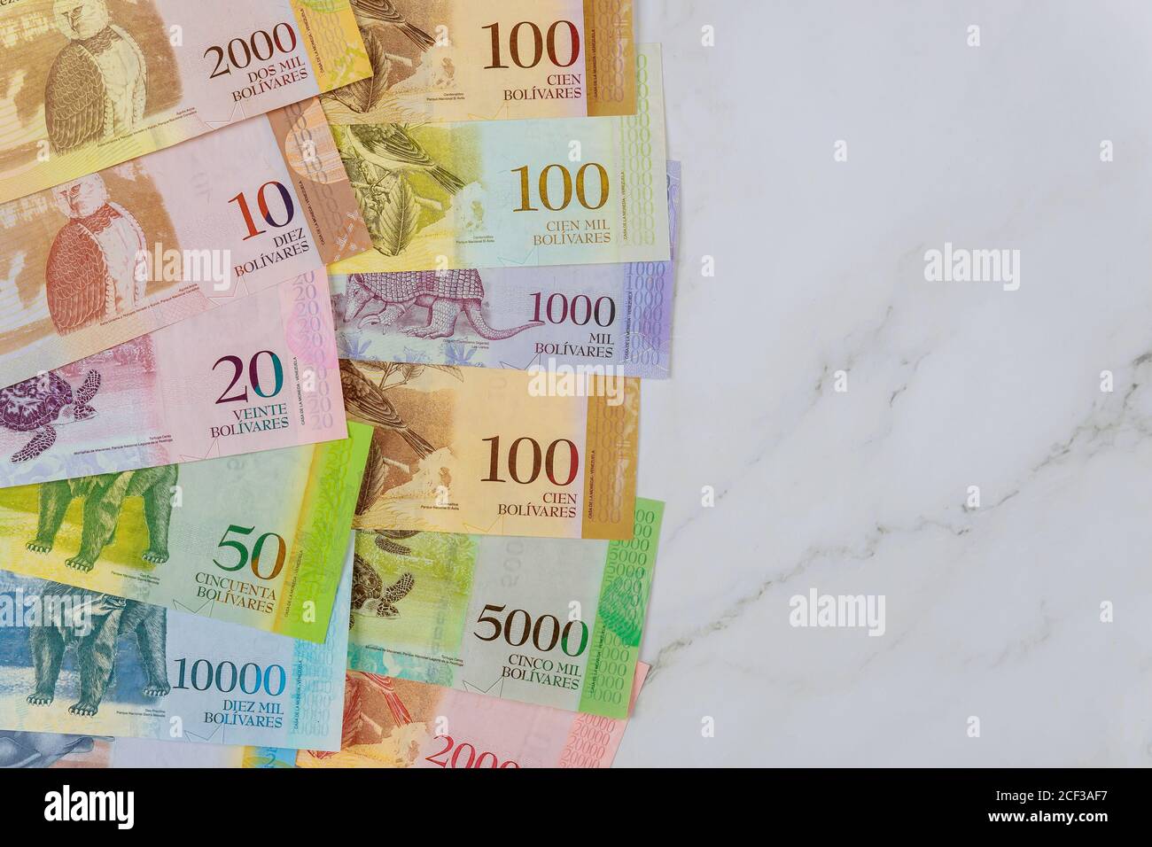 Venezuelan Bolivar banknote with different currency paper bills Stock ...