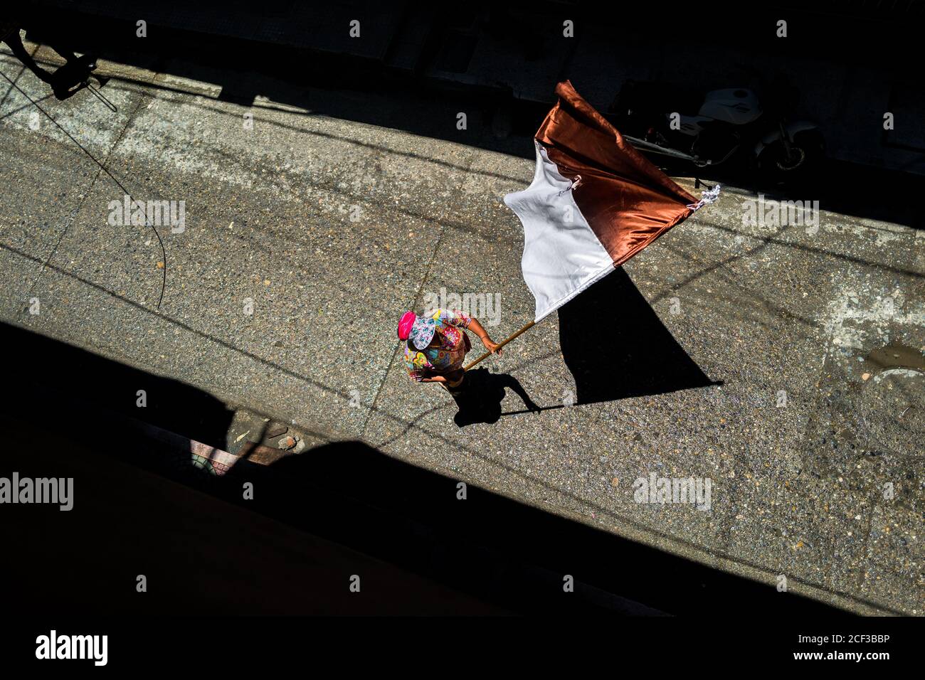 An Afro-Colombian dancer of the Yescagrande neighborhood waves the flag ...
