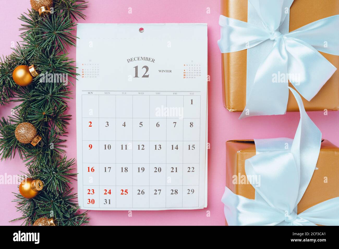 Calendar page of december with festive decorations on pink background ...