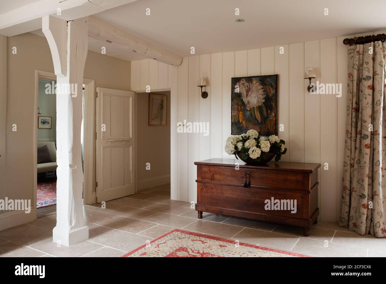 Wooden table in country style entrance hall Stock Photo - Alamy
