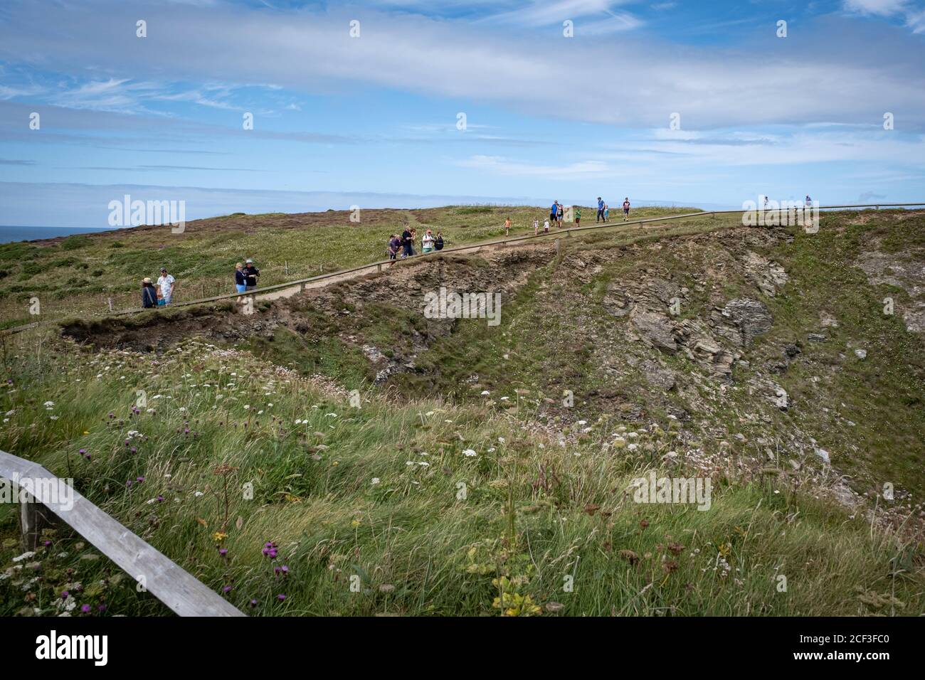 Walkers on the South West Coastal Path at Godrevy, Cornwall, England ...