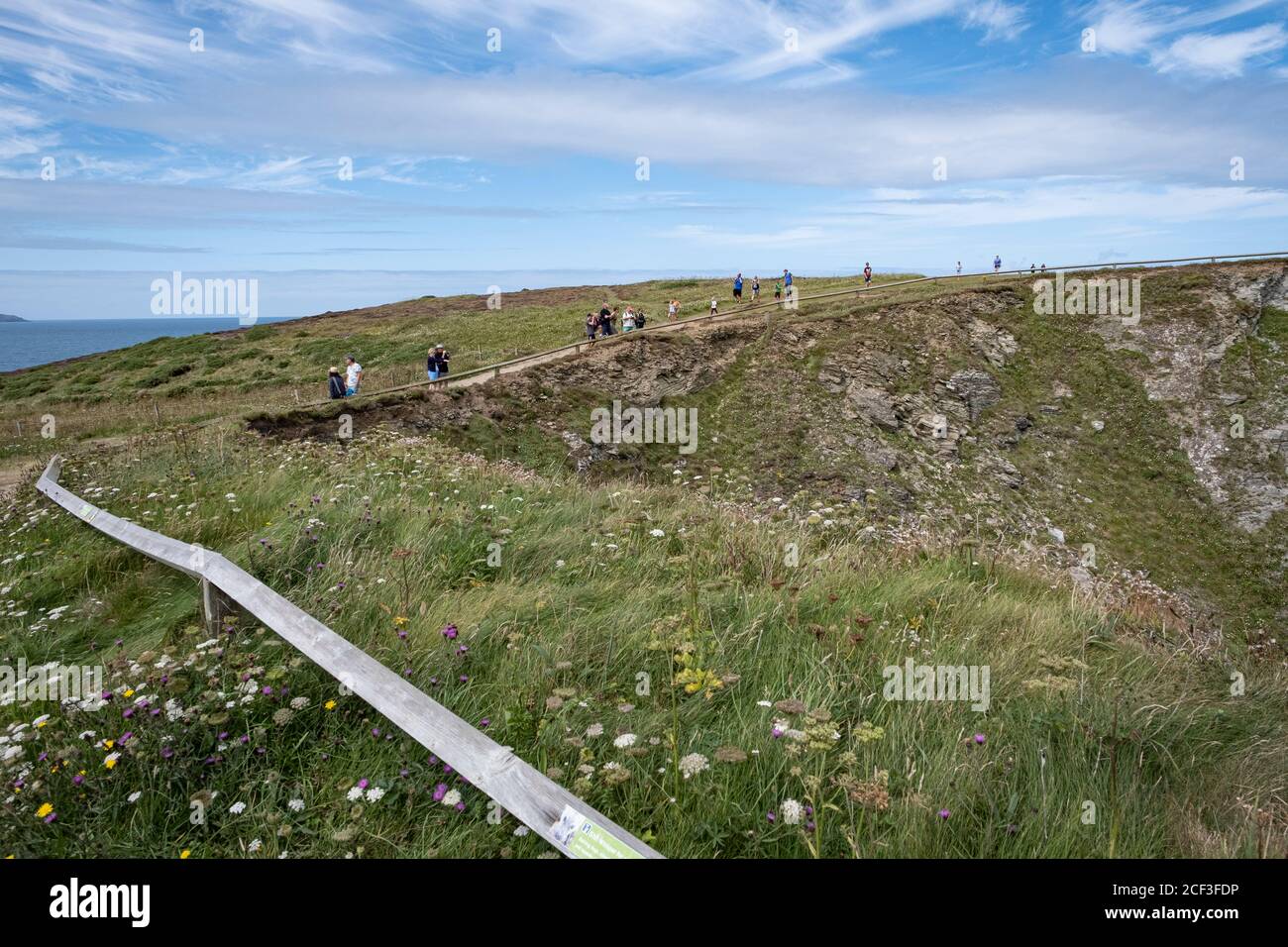 Walkers on the South West Coastal Path at Godrevy, Cornwall, England ...